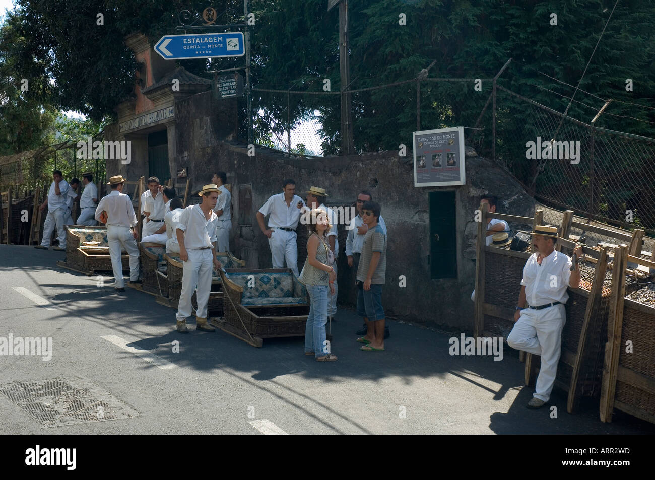 People tourists visitors taking a toboggan Basket ride at Monte Funchal ...