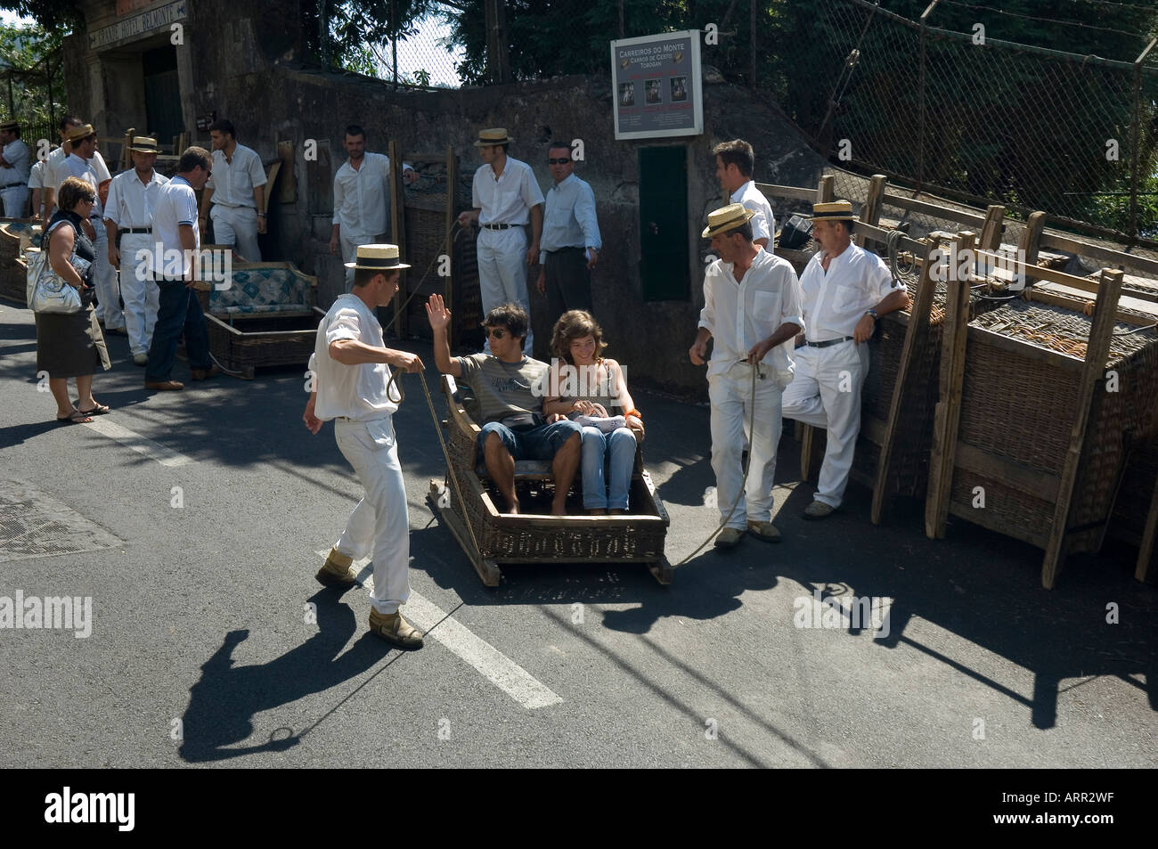 People tourists visitors taking a toboggan Basket ride at Monte Funchal ...