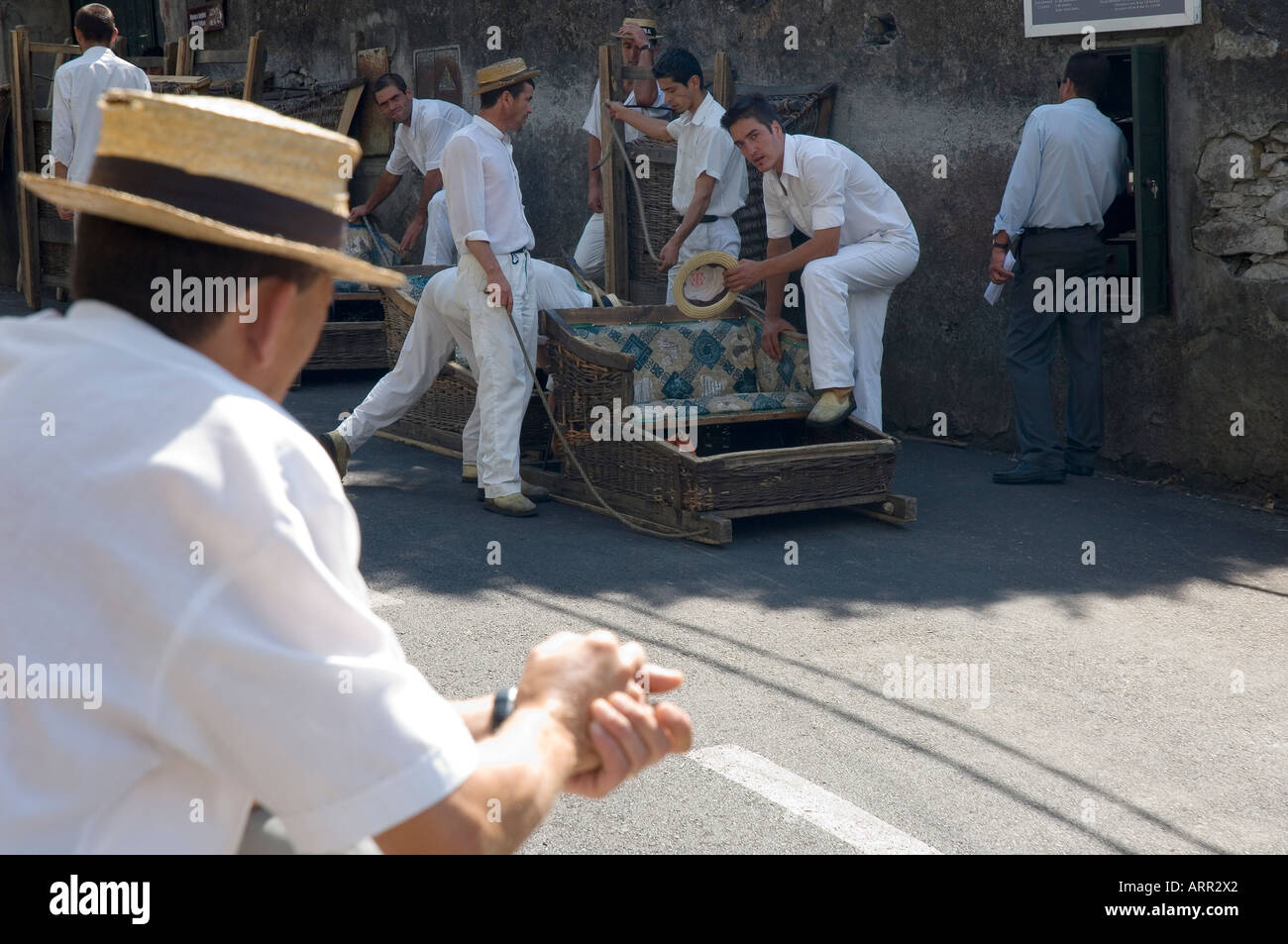 People tourists visitors taking a toboggan Basket ride at Monte Funchal ...