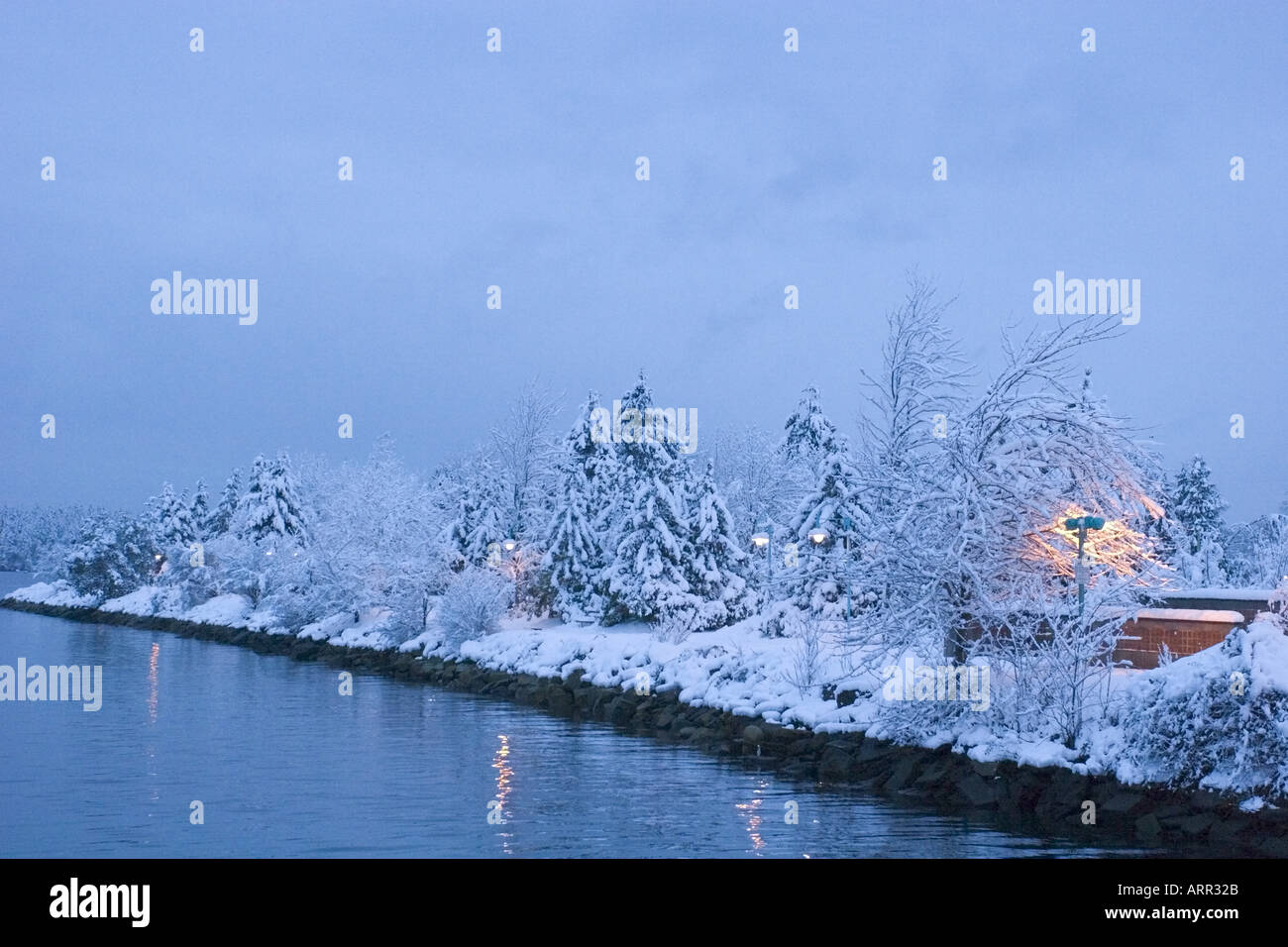 Maffeo Sutton Park and Seawall Harbourside walkway reflect in water at ...