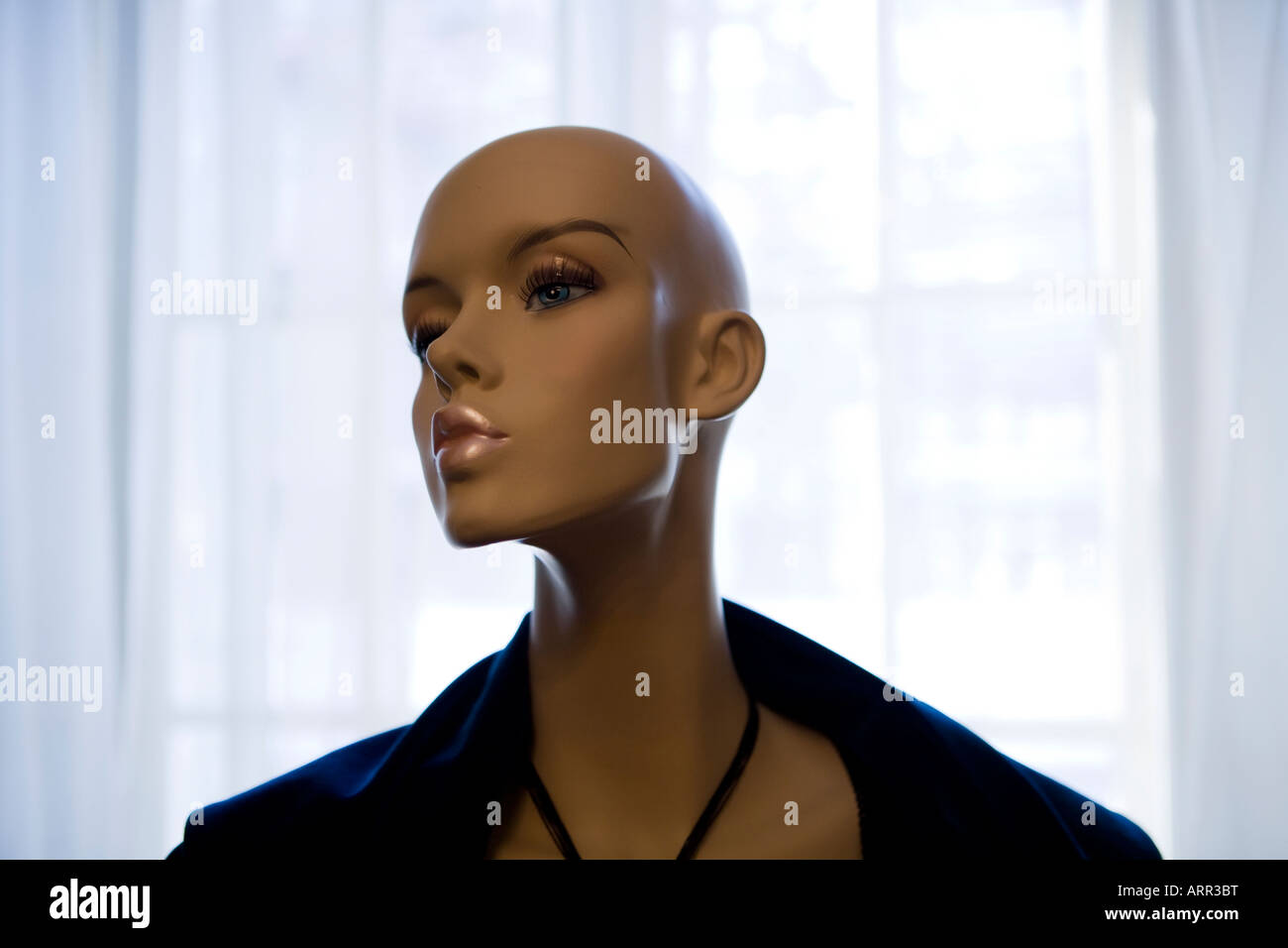 female plastic mannequin posing like a woman, wearing a dark coat Stock ...