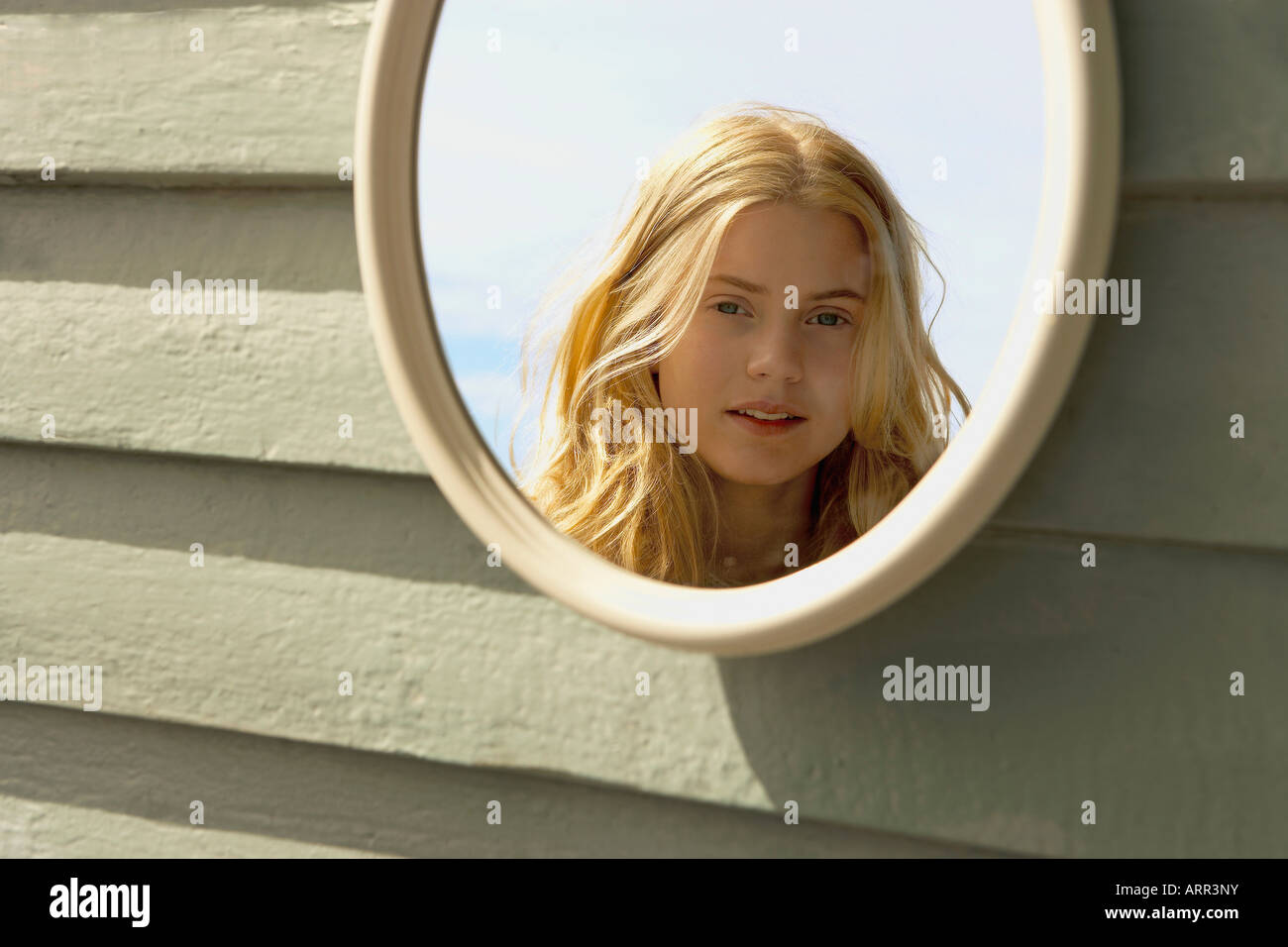 Young Woman Looking in Mirror outside Stock Photo - Alamy