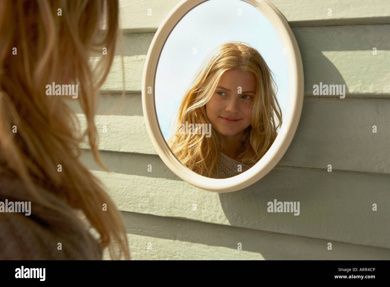 Young Woman Looking in Mirror outside Stock Photo - Alamy