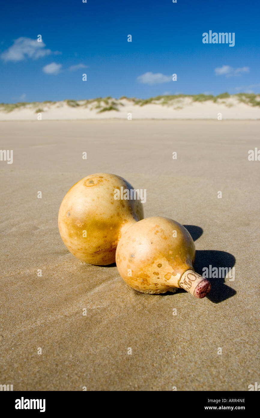 true wood bottle with sos message in beach Stock Photo - Alamy