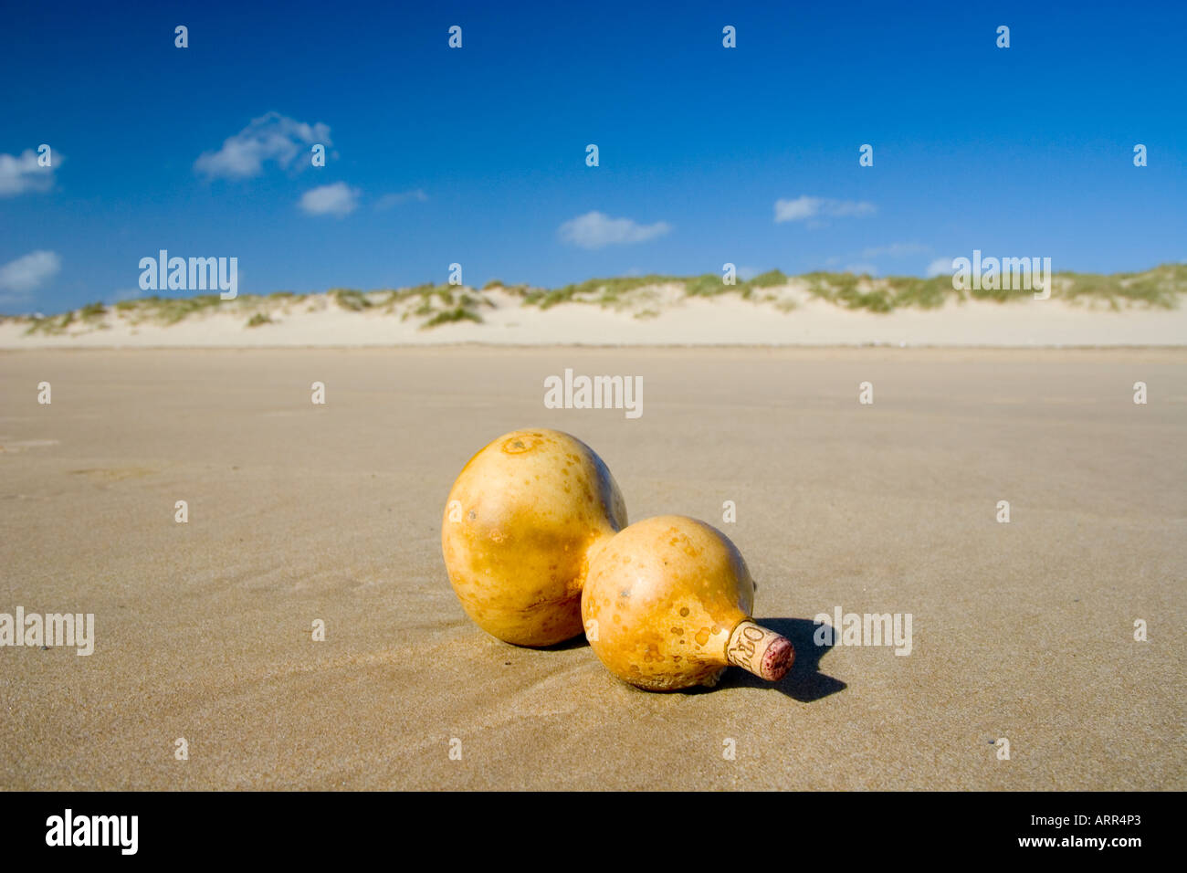 true wood bottle with sos message in beach Stock Photo - Alamy