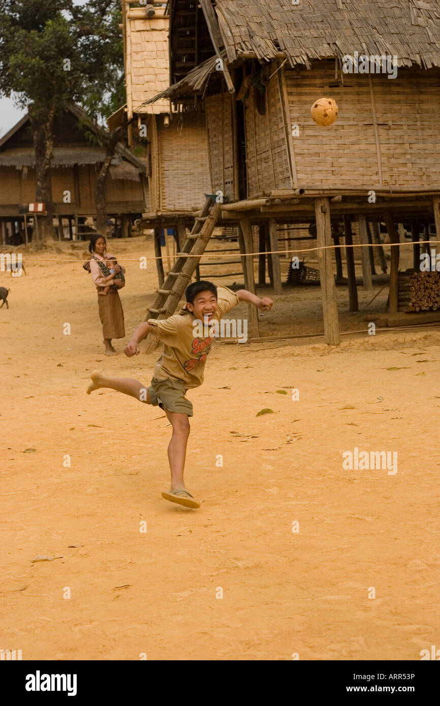 Kids playing ball in a village near Muang Ngoi Laos Stock Photo - Alamy