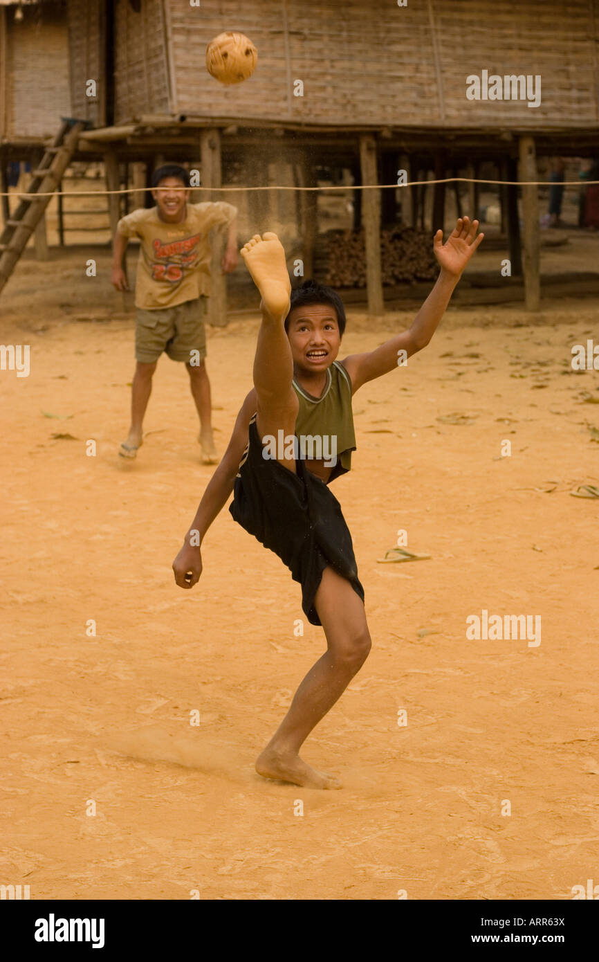 Kids playing ball in a village near Muang Ngoi Laos Stock Photo - Alamy