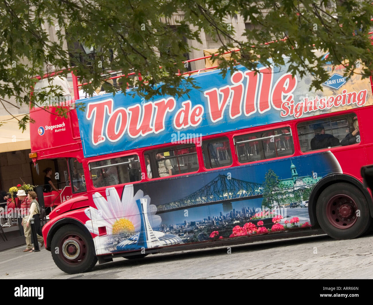 A bright and colourful 'Tour de Ville' open topped Sightseeing bus in ...