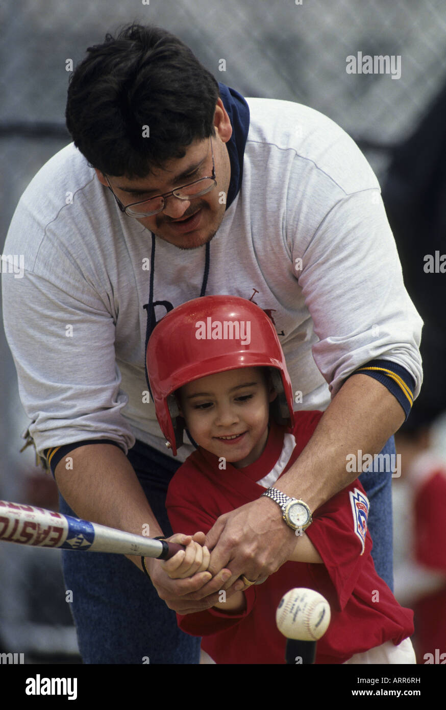 Dad coaching his son during a Tee Ball game Stock Photo - Alamy