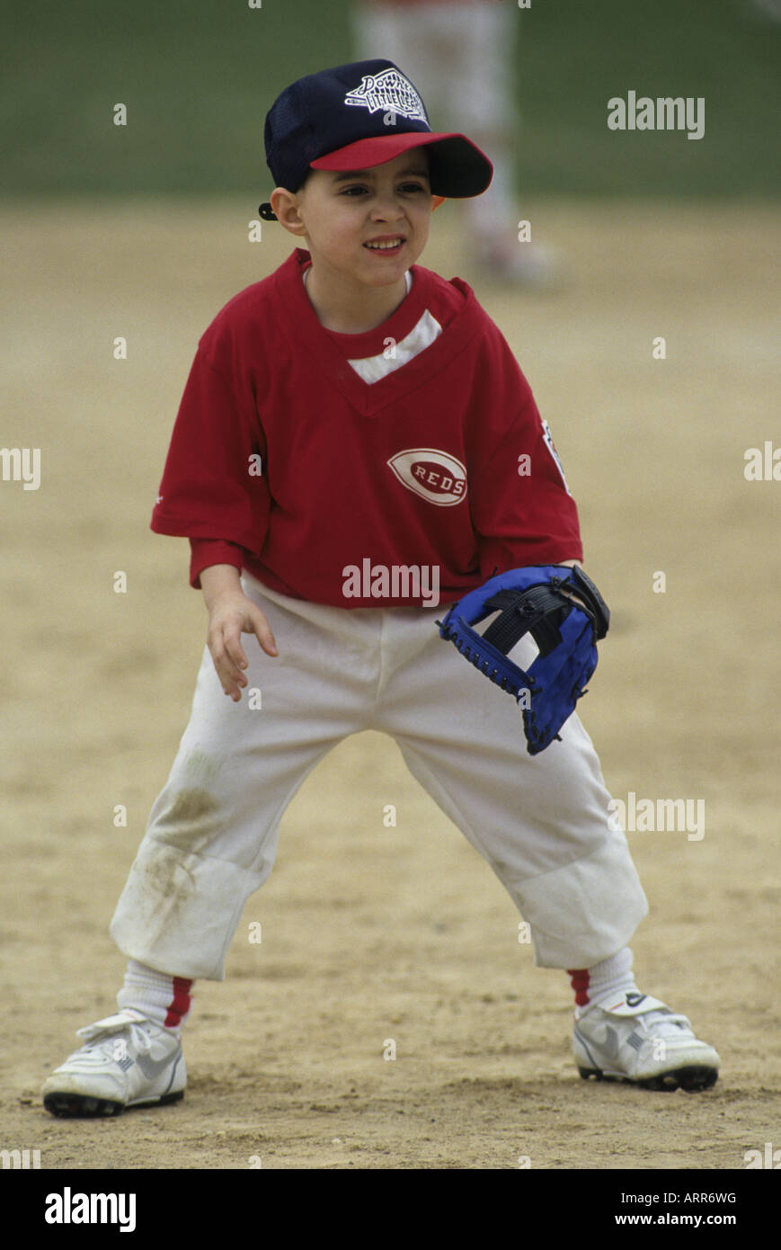 Young boy at short stop during a tee ball game Stock Photo - Alamy