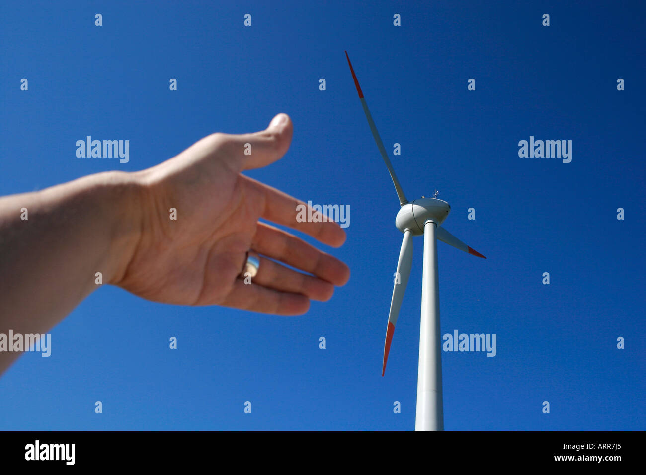 wind turbine in clear blue sky hand, great for energy and ...