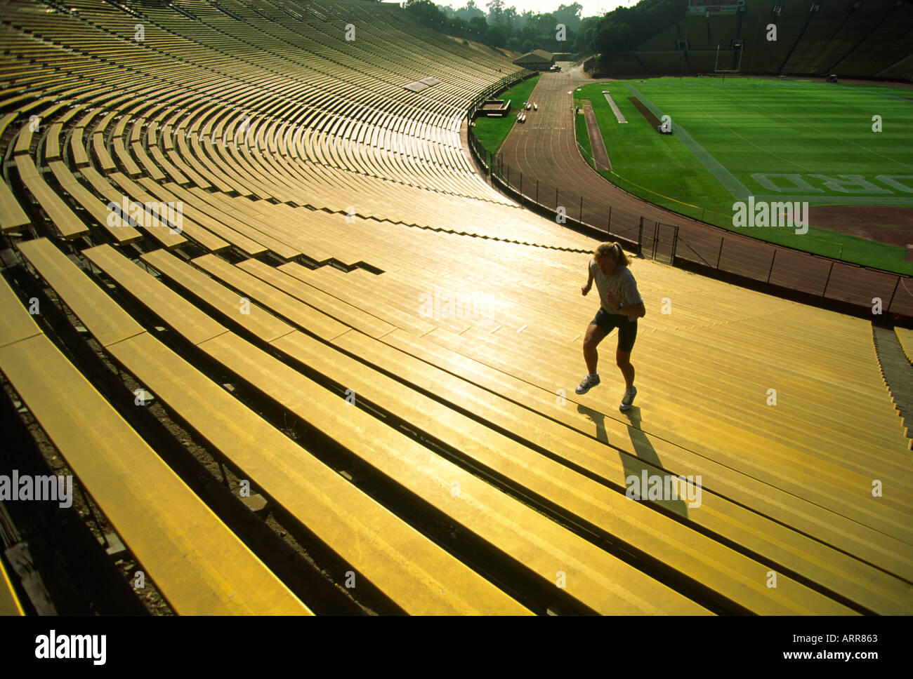 Model released woman running up stadium stairs Stock Photo - Alamy