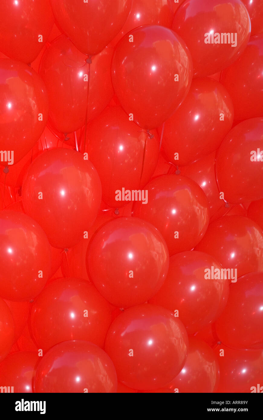 Close up of helium filled red balloons for sale Stock Photo - Alamy