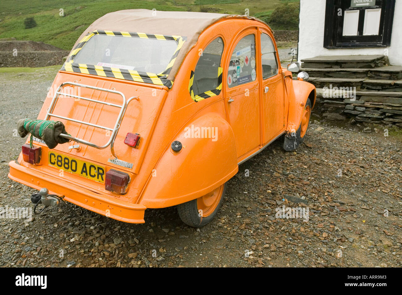 a customized citroen 2CV painted bright orange, Coniston, Lake district ...