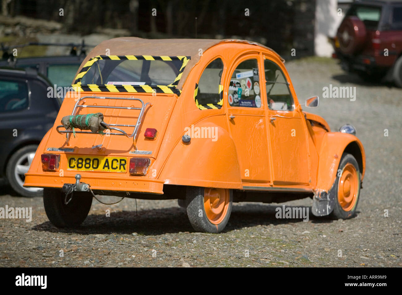 a customized citroen 2CV painted bright orange, Coniston, Lake district ...
