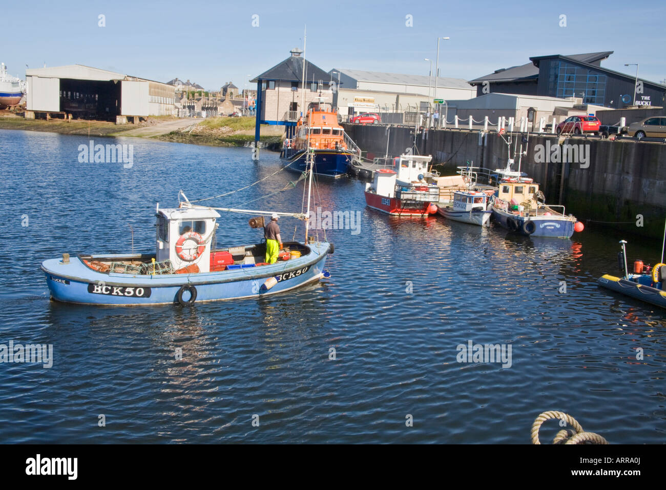 A small fishing boat returning to port with fish at Buckie on the Moray ...