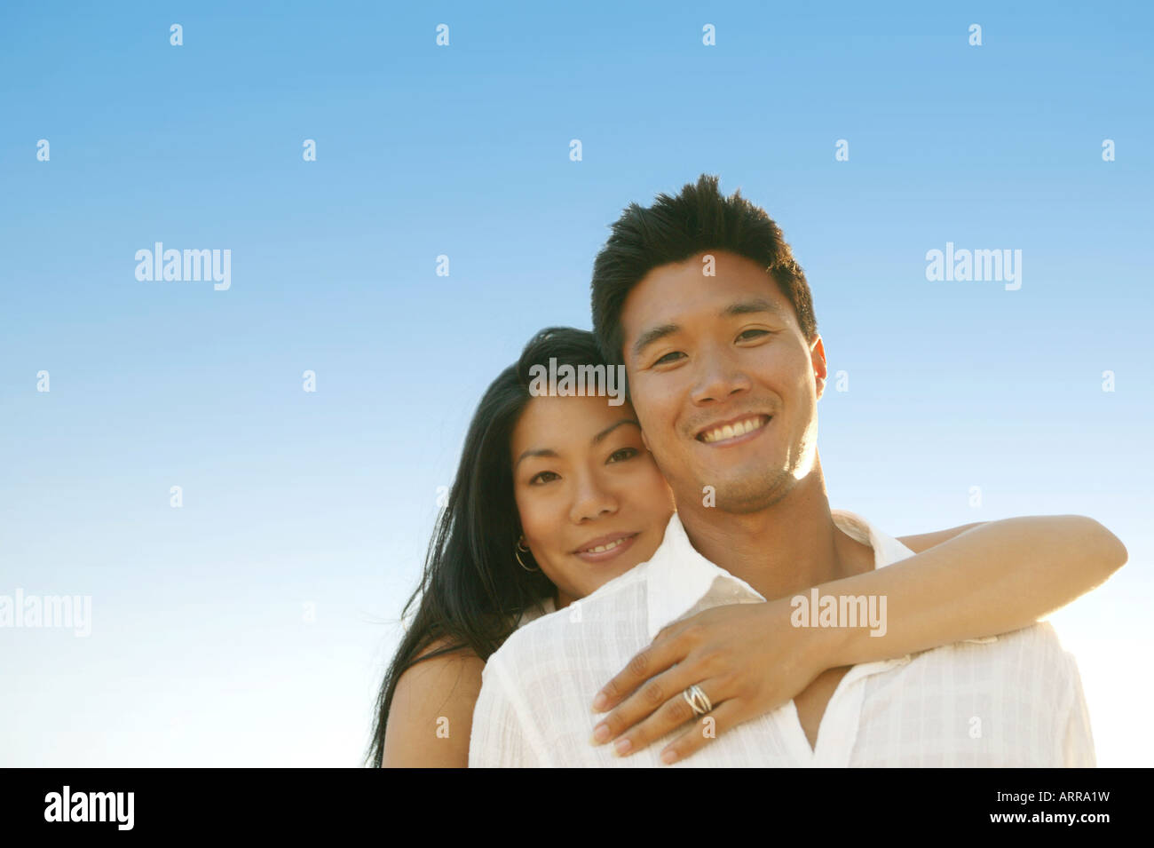Couple in Front of Blue Sky Stock Photo - Alamy