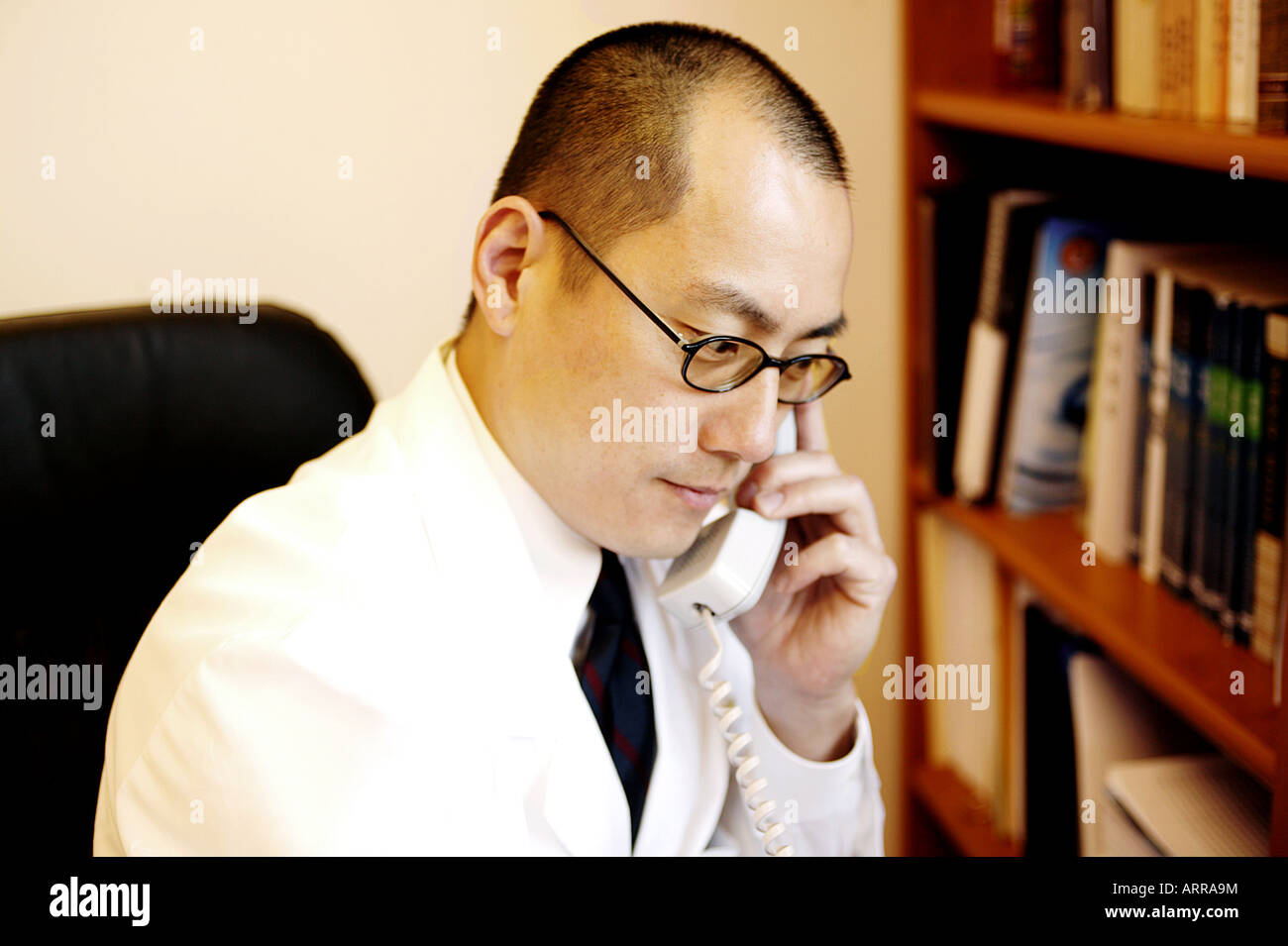 Chinese doctor talking on phone hi-res stock photography and images - Alamy