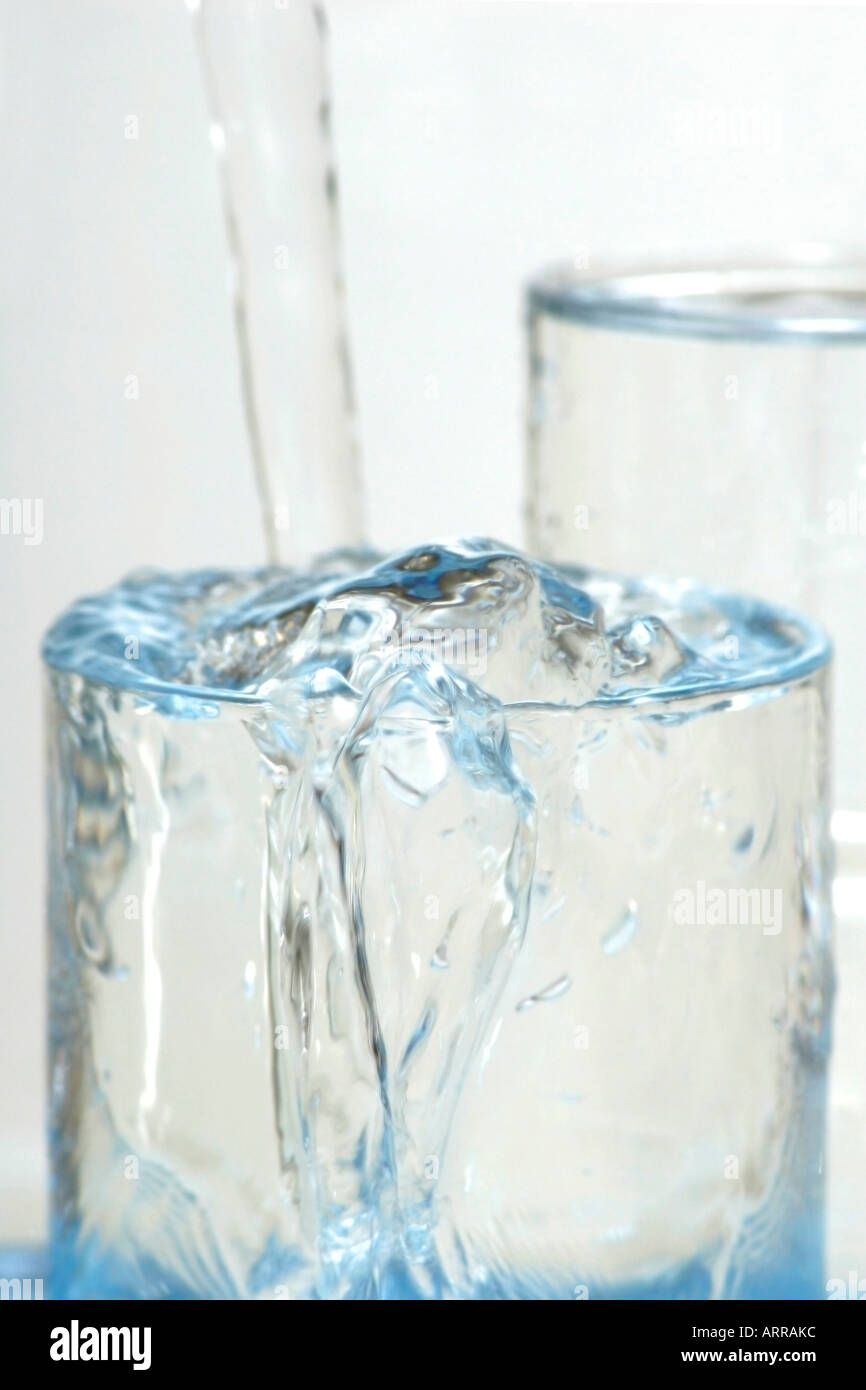 Mineral Water falling to glass cup Stock Photo - Alamy
