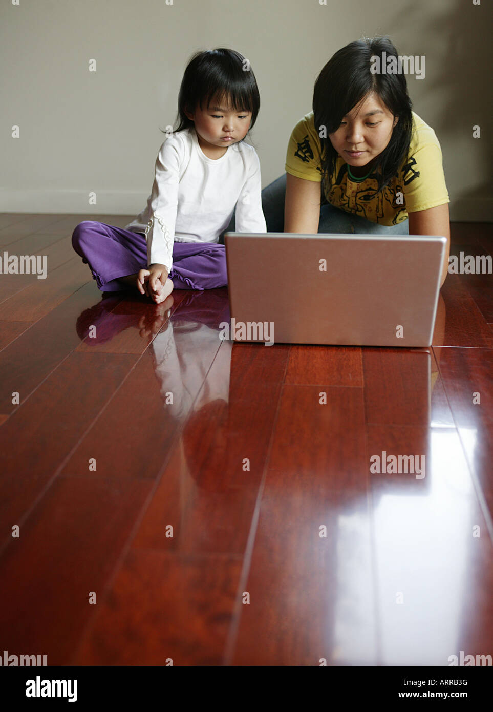 Woman with Little Girl on Laptop Computer Stock Photo - Alamy