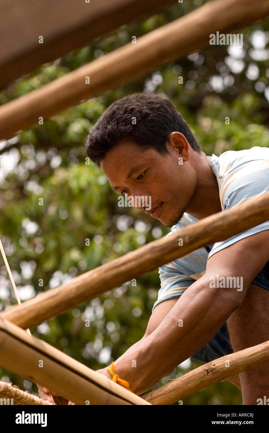Man fixes roof Attapeu province Laos Stock Photo - Alamy