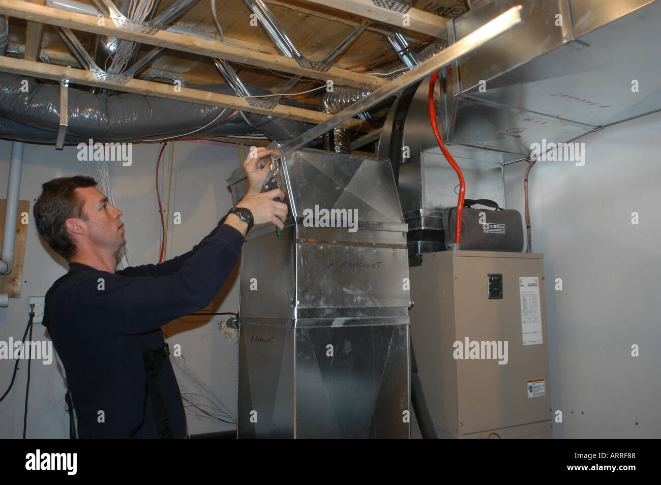 Man installing ventilation system Stock Photo - Alamy