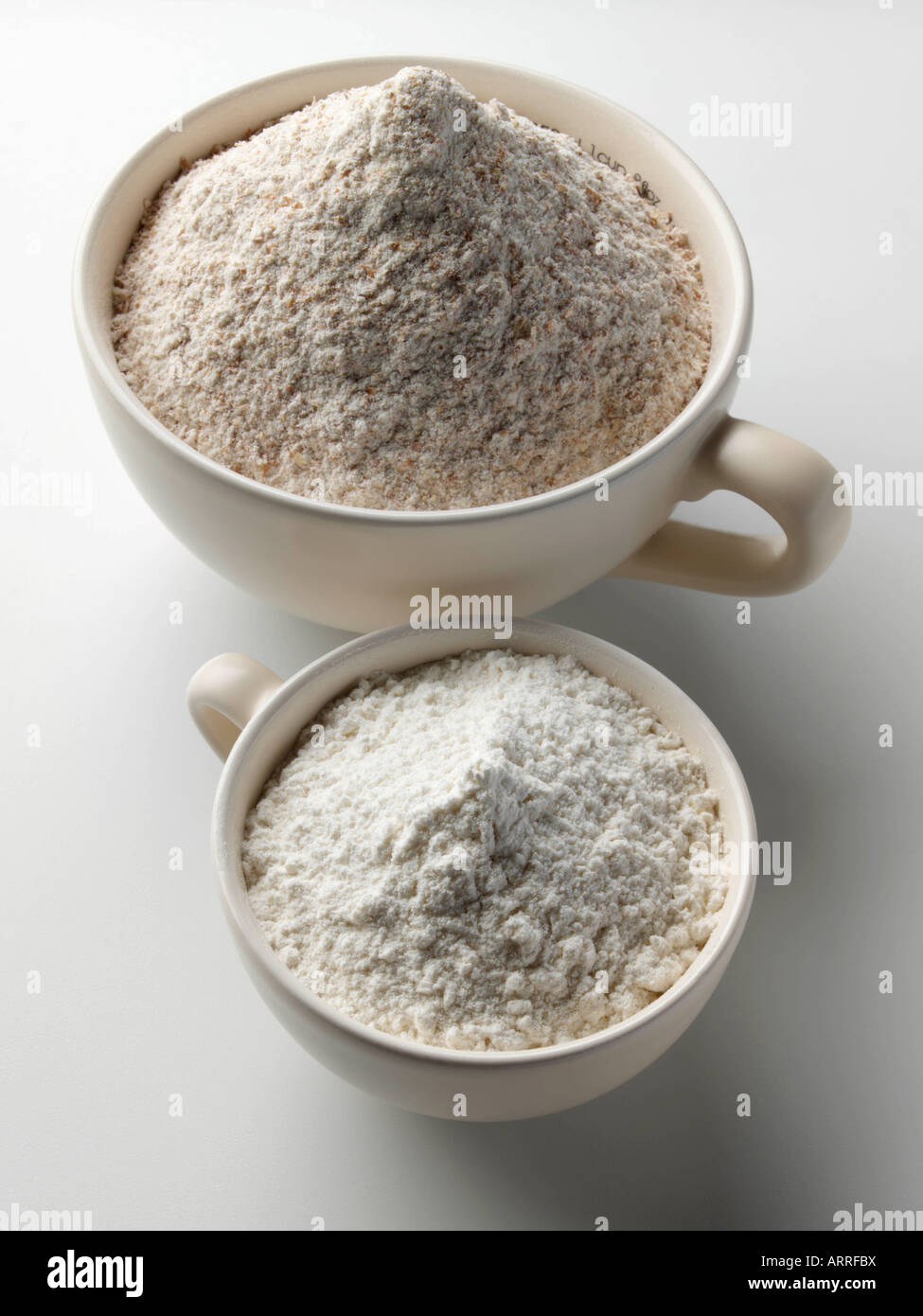 Wholemeal and white flour ingredients on a white background editorial ...
