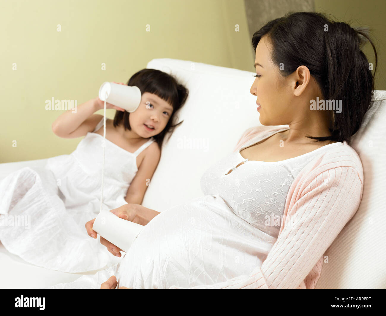 girl listen to baby in mum tummy Stock Photo - Alamy