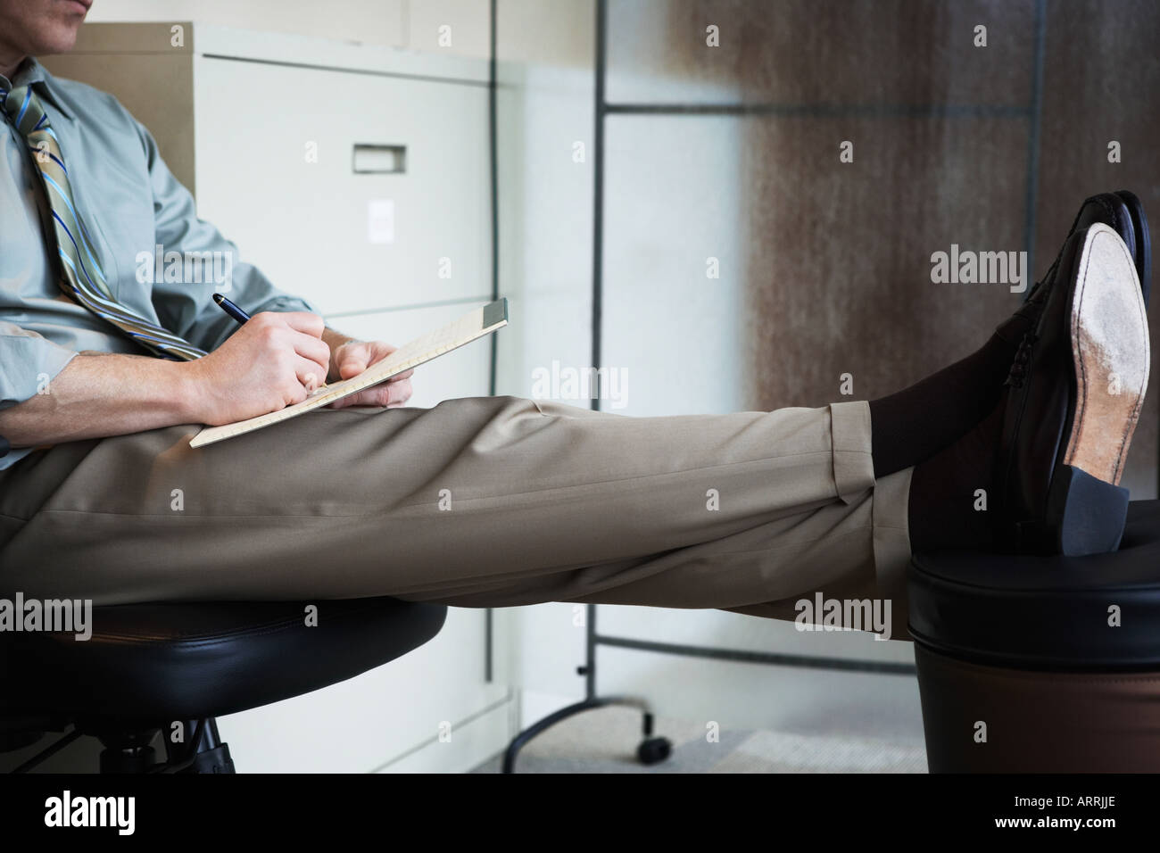 Office worker writing notes Stock Photo - Alamy