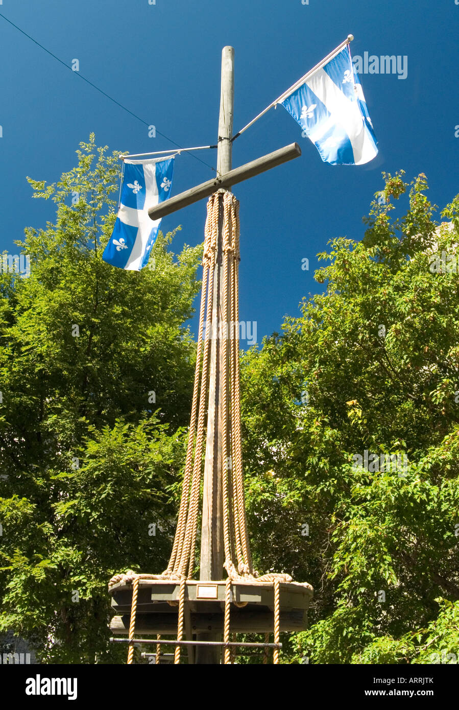 The Quebec Provincial Flag flying on a mast in the Lower Town area of ...