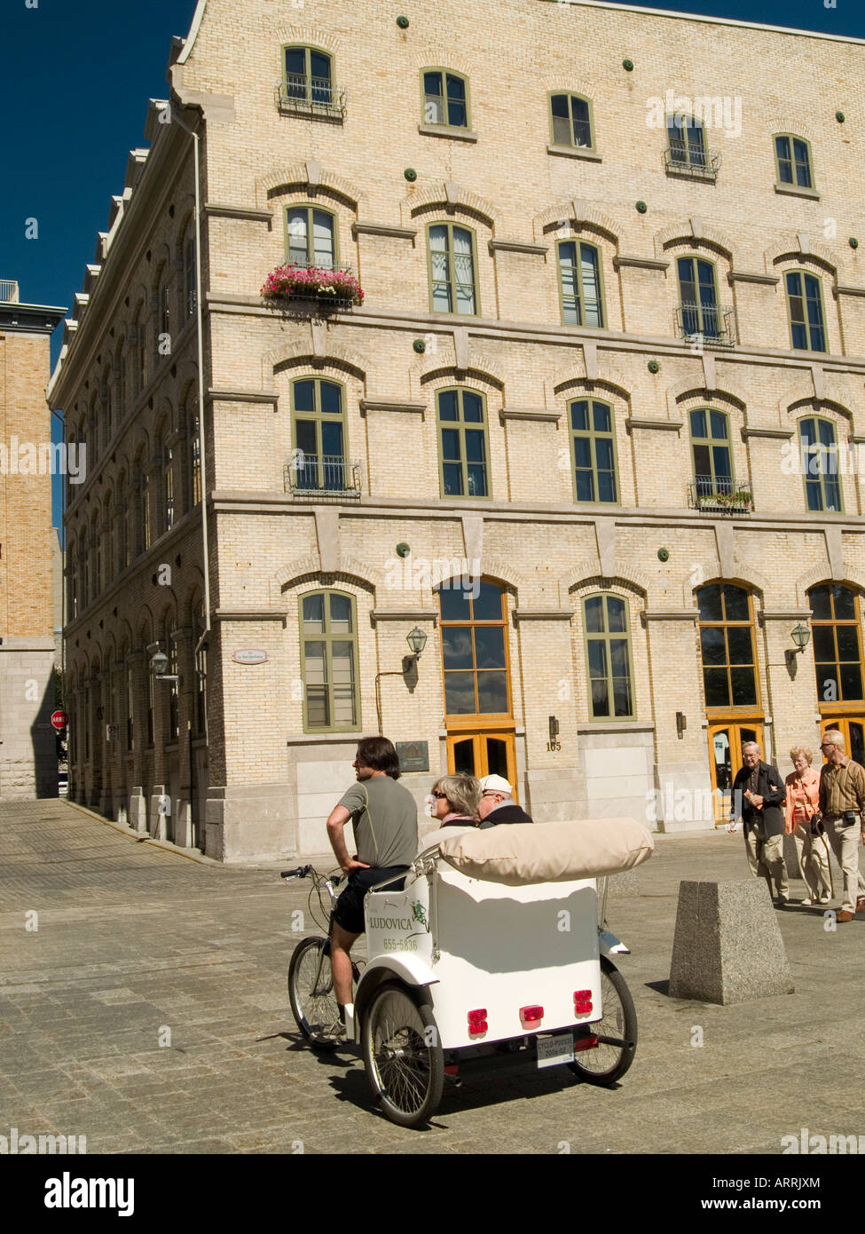 Tourists seeing the sights of the Lower Town area of Quebec City via a ...