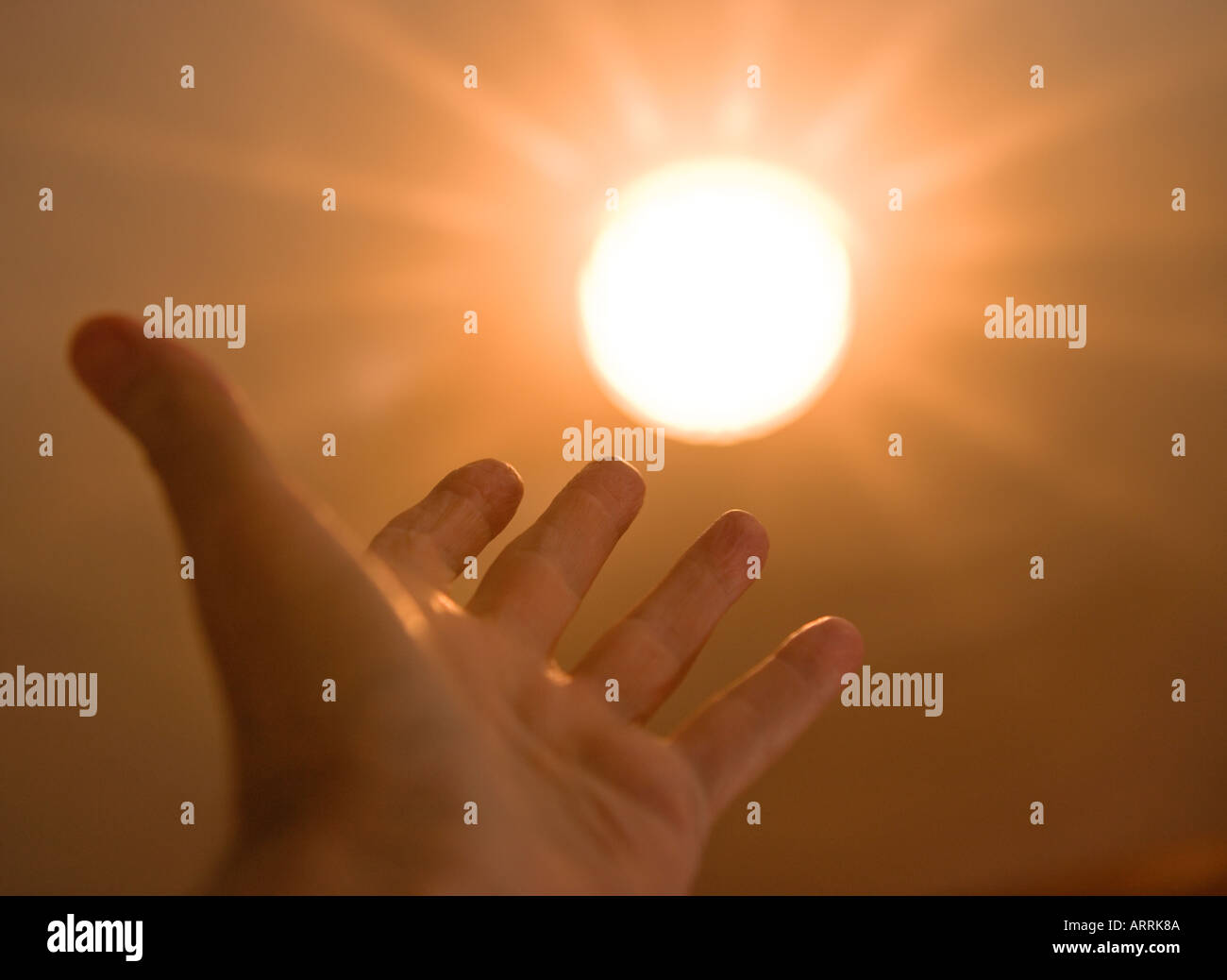 Hand reaching for sun Stock Photo - Alamy