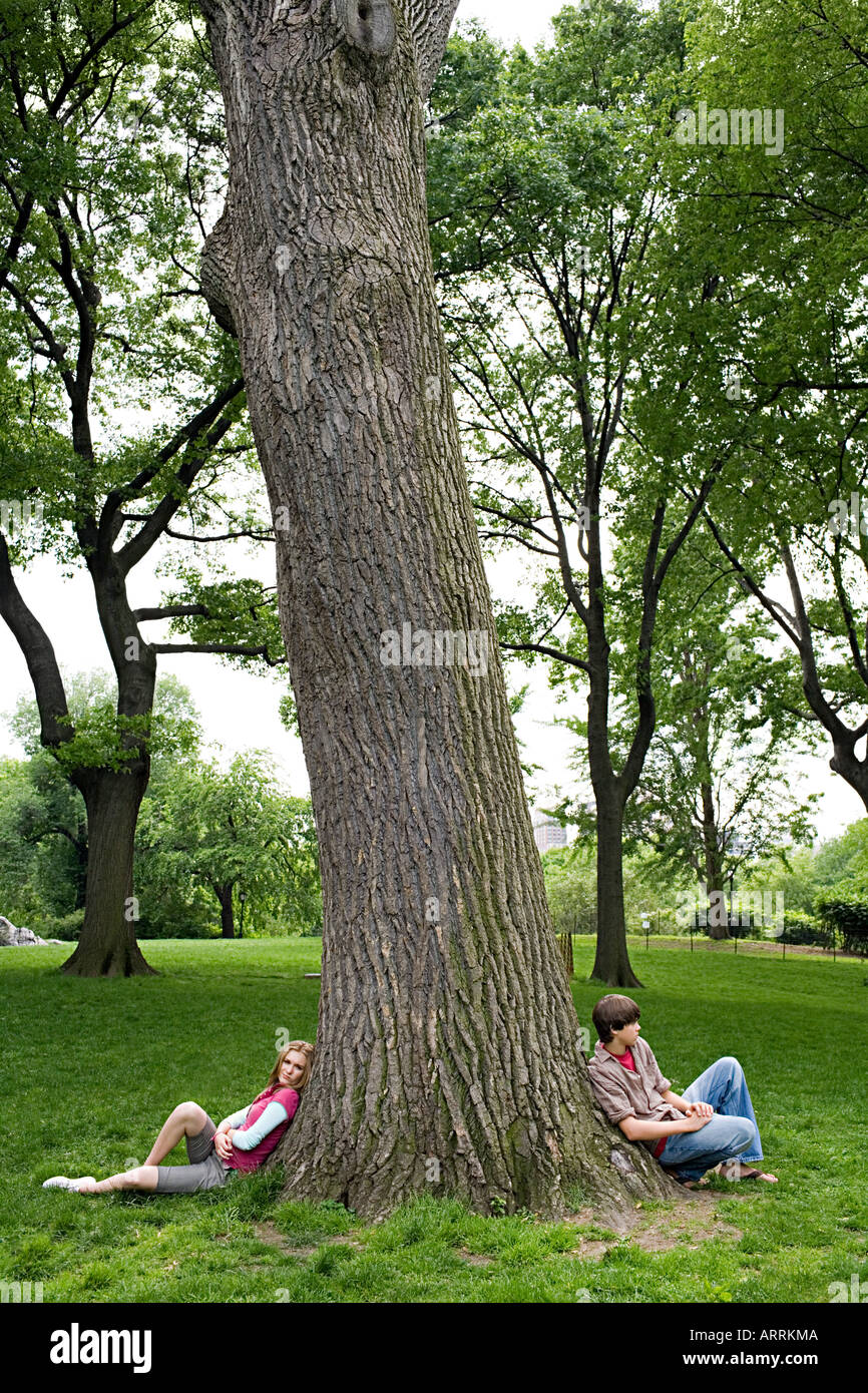 Couple leaning against a tree hi-res stock photography and images - Alamy