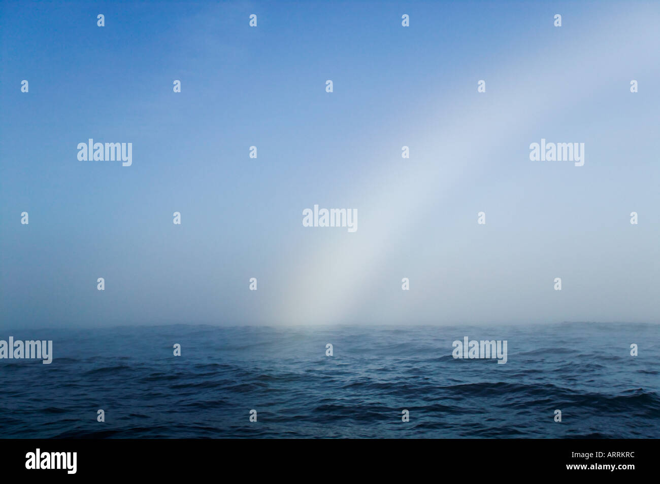 Rainbow fading over the ocean Stock Photo - Alamy