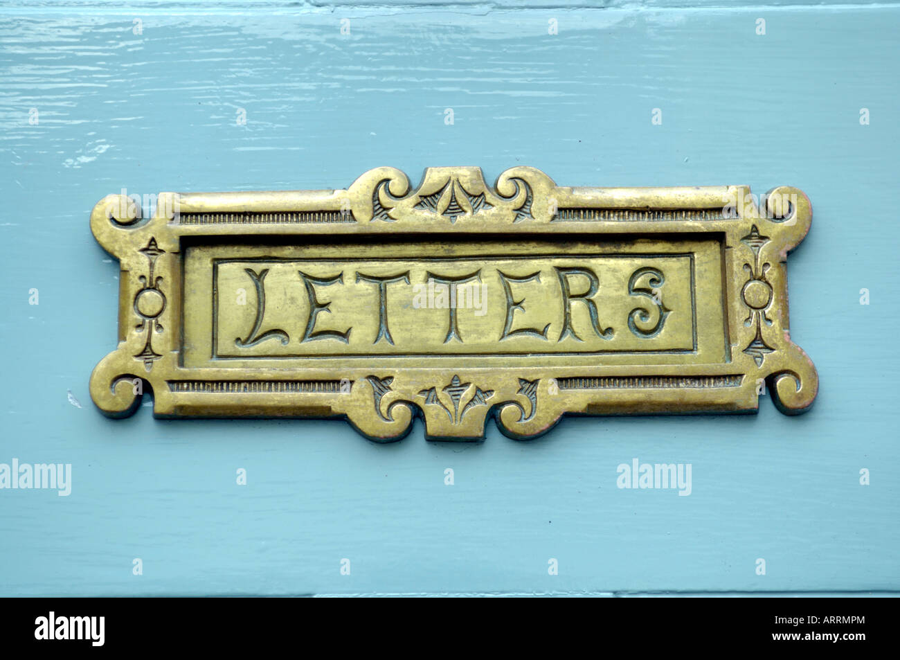 Ornate letterbox in wooden door Stock Photo - Alamy
