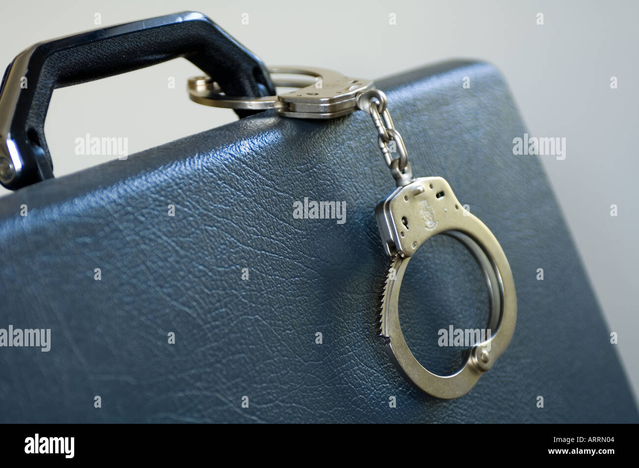 handcuffs and briefcase Stock Photo - Alamy