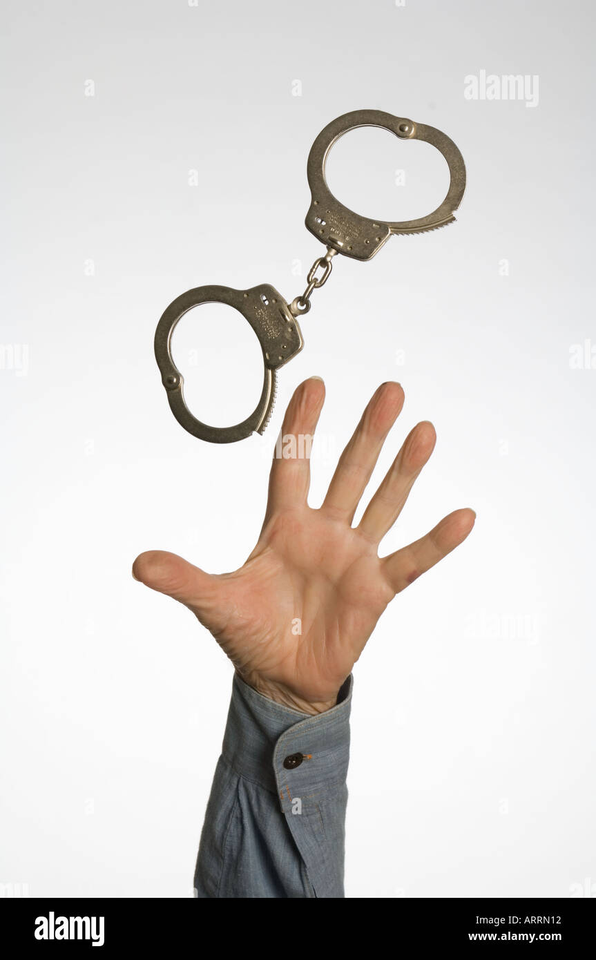 hand tossing handcuffs into air Stock Photo - Alamy
