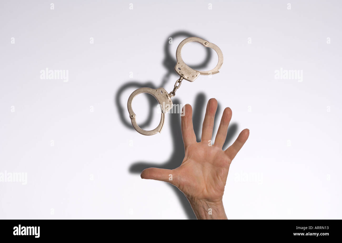 hand tossing handcuffs into air Stock Photo - Alamy