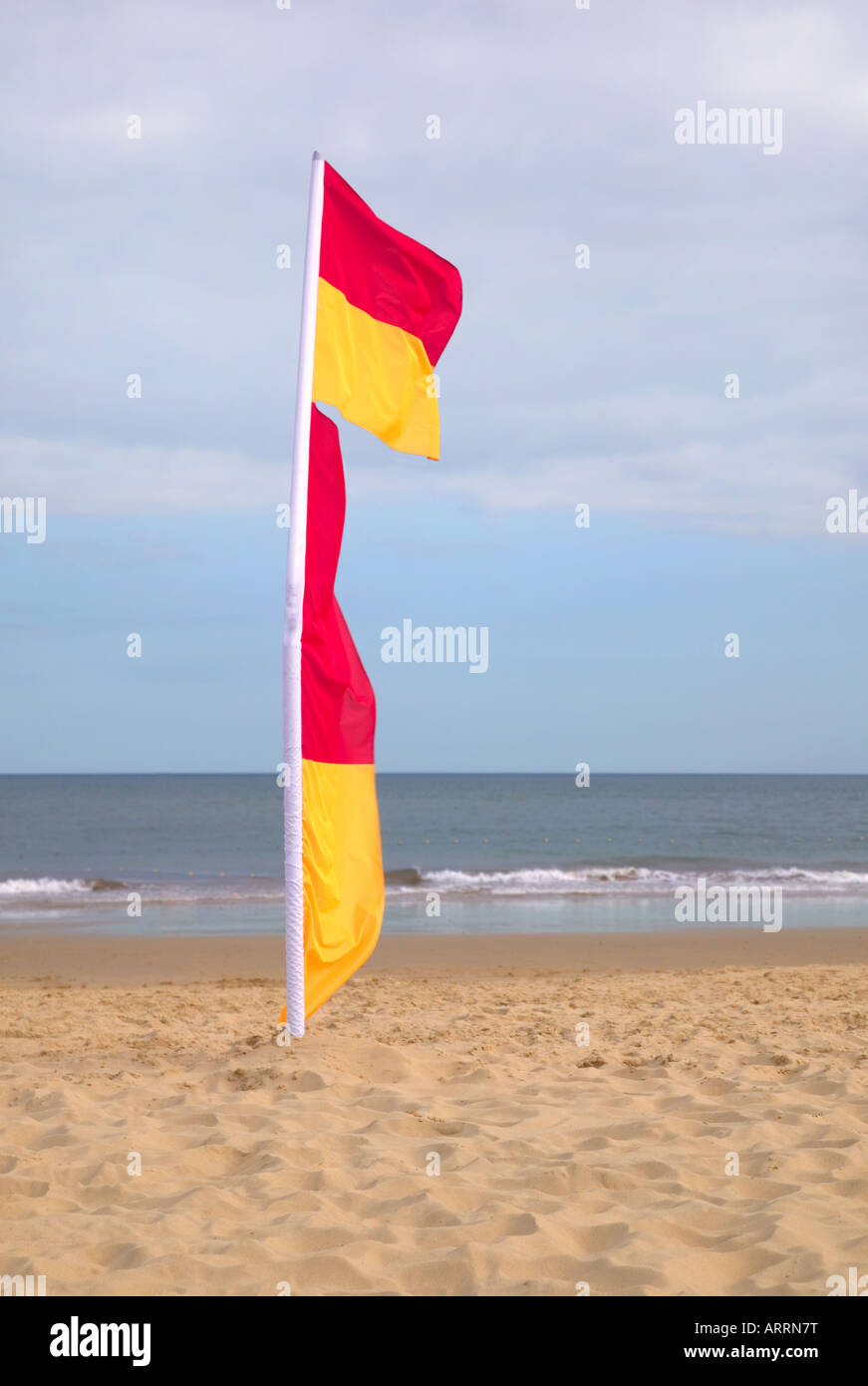 Lifeguard flag in the sand Stock Photo - Alamy