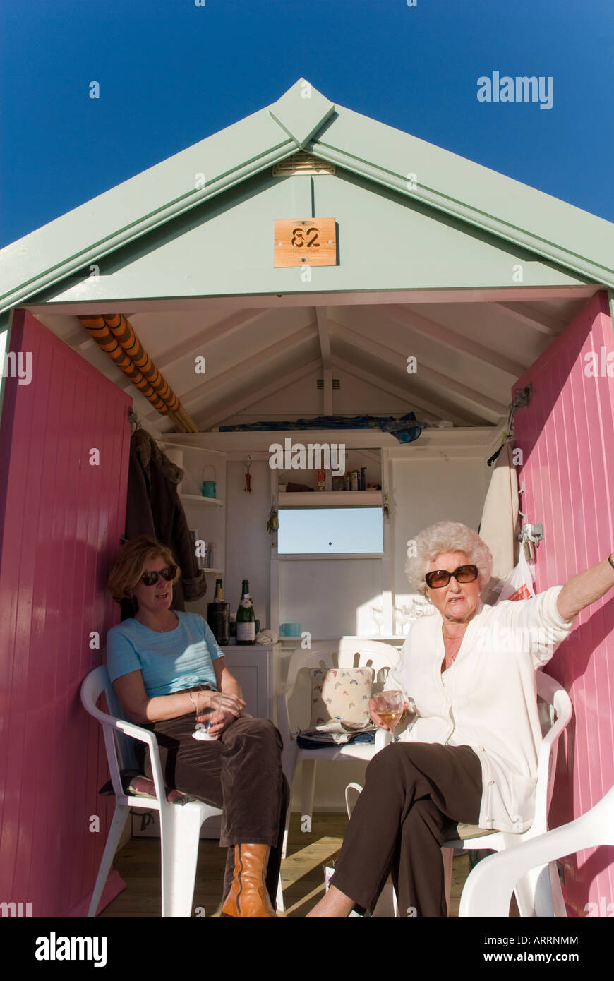 Brighton beach huts woman hi-res stock photography and images - Alamy