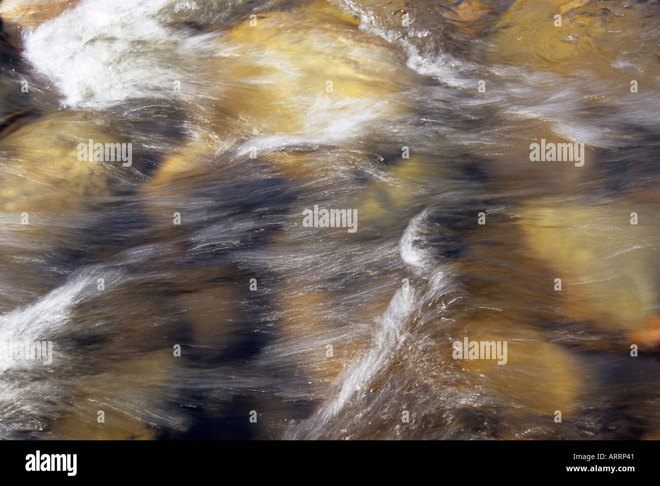 The beautiful motion of rushing water in a scenic waterfall landscape ...
