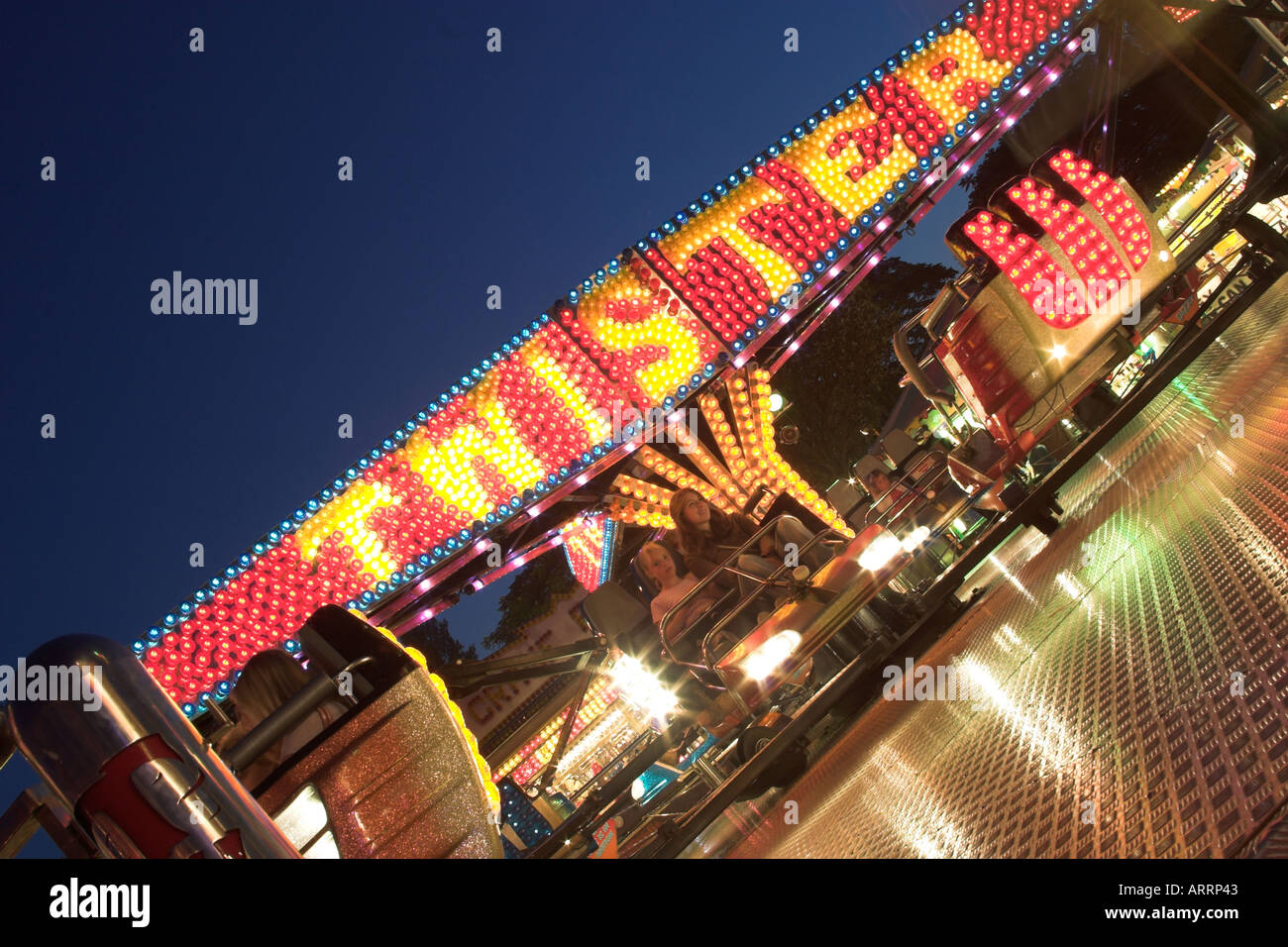 A fairground attraction at night Stock Photo - Alamy
