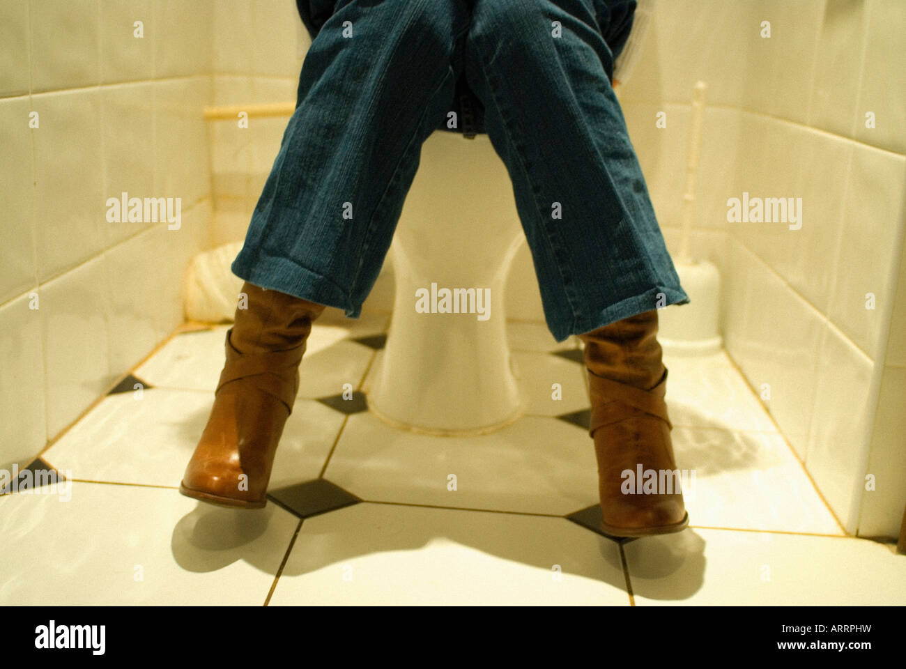 Sitting on the toilet Stock Photo - Alamy