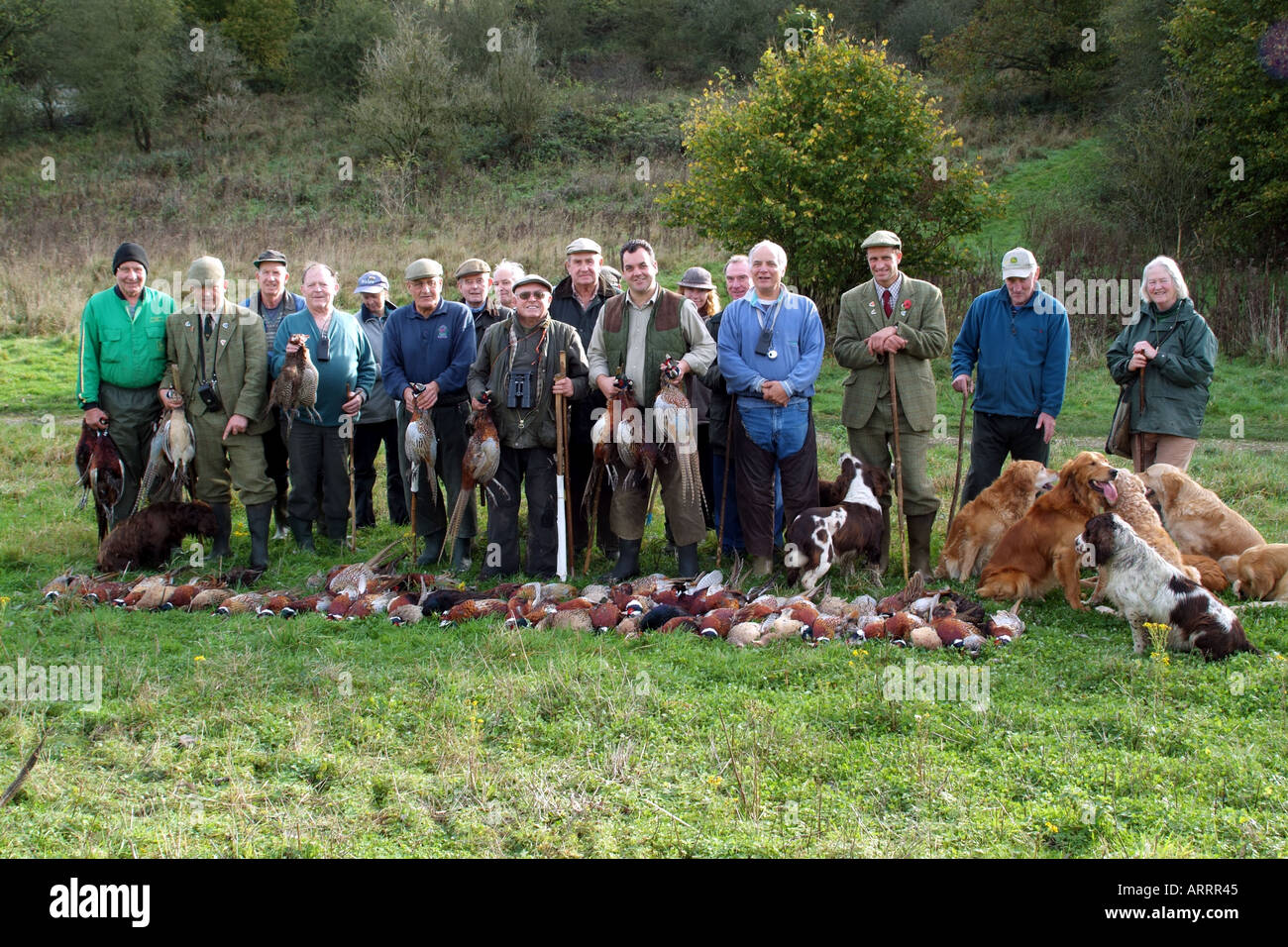 Farm workers beaters and gamekeeper and their dogs pose for a group ...