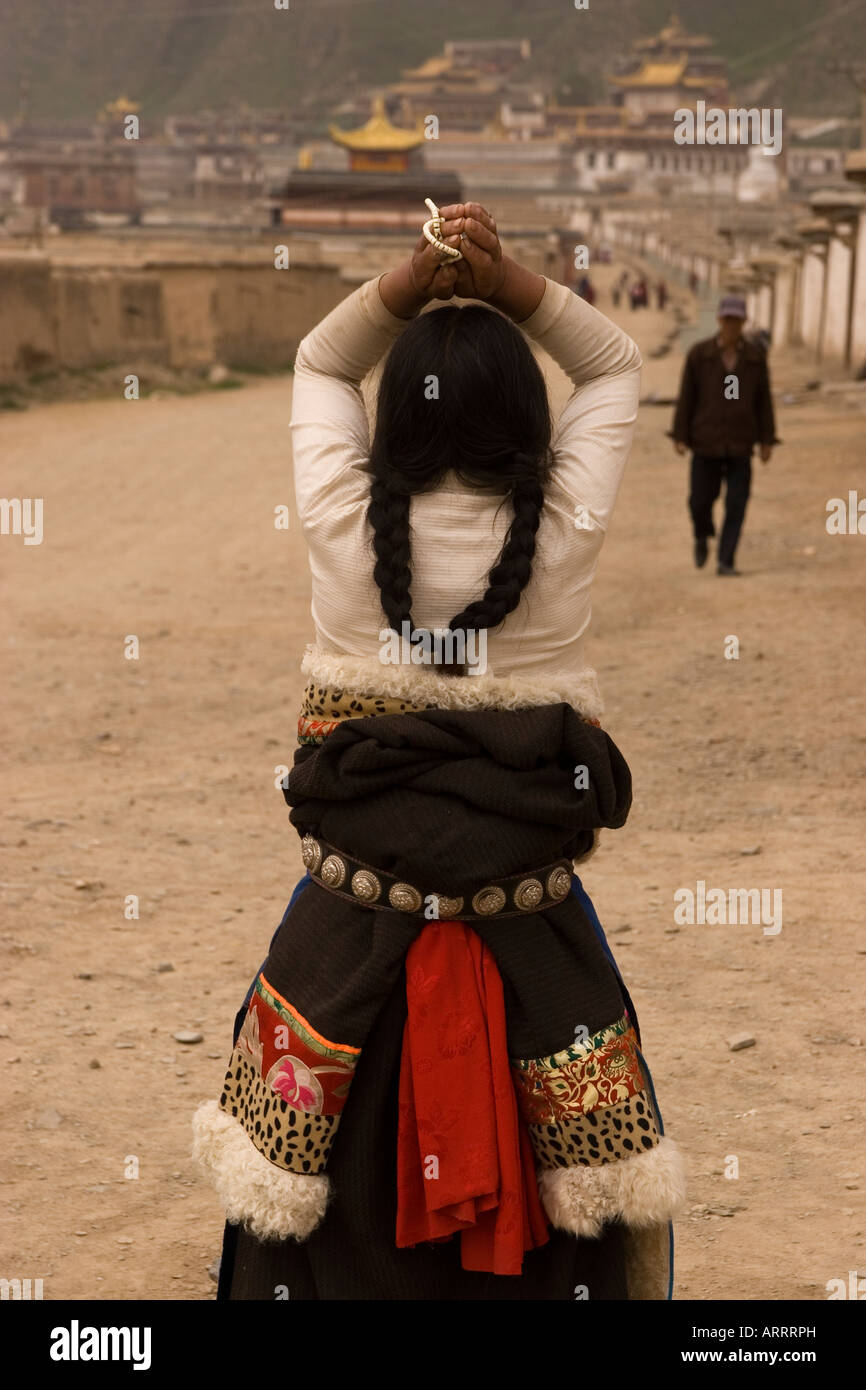 Tibetan pilgrim woman circumambulating Labrang Monastery, Xiahe Stock ...