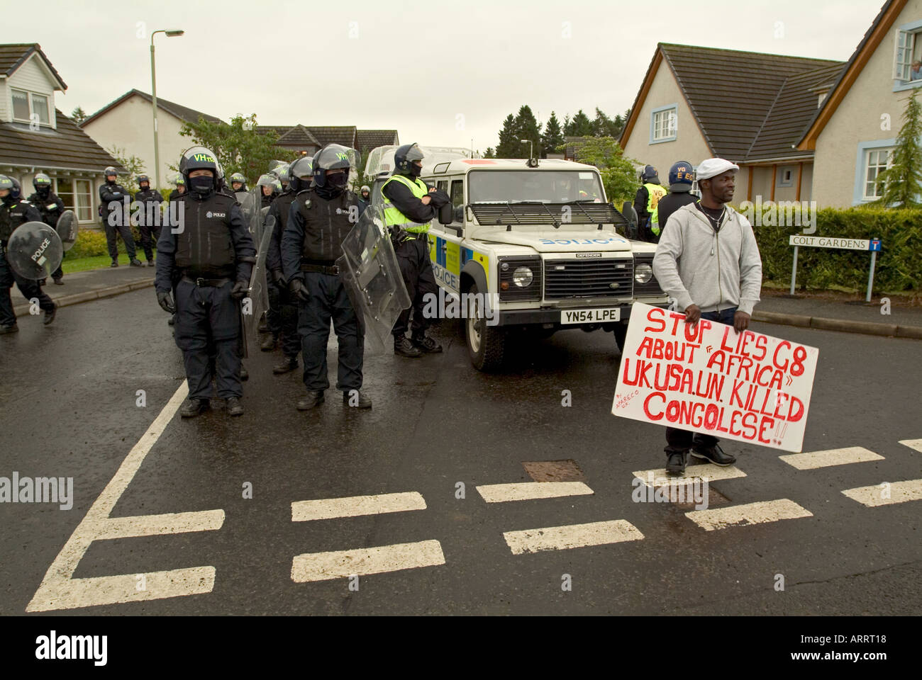 Congolese protester beside riot police at Gleneagles G8 summit, 2005 ...