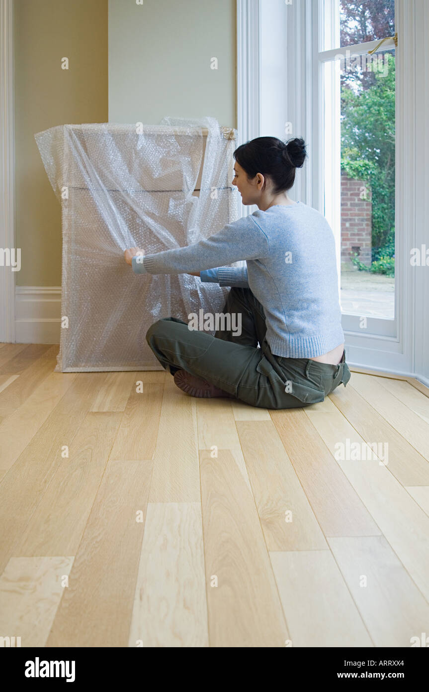 Woman unpacking picture Stock Photo - Alamy