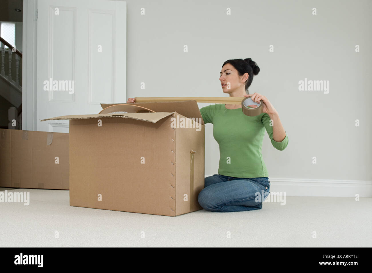 Woman packing up boxes Stock Photo - Alamy