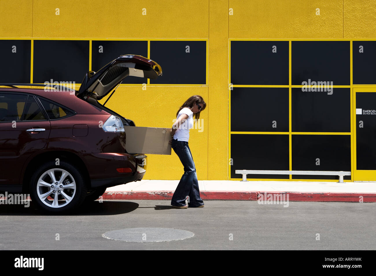 Woman packing boxes into trunk Stock Photo - Alamy