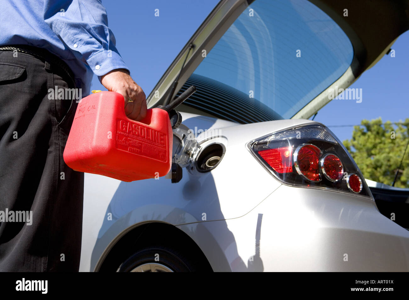 Man filling tank with gas Stock Photo - Alamy
